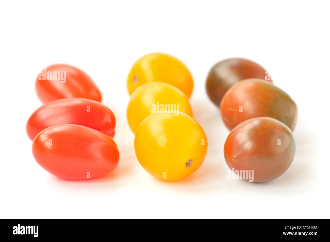 Cherry tomatoes of different colors on a white background Stock Photo ...