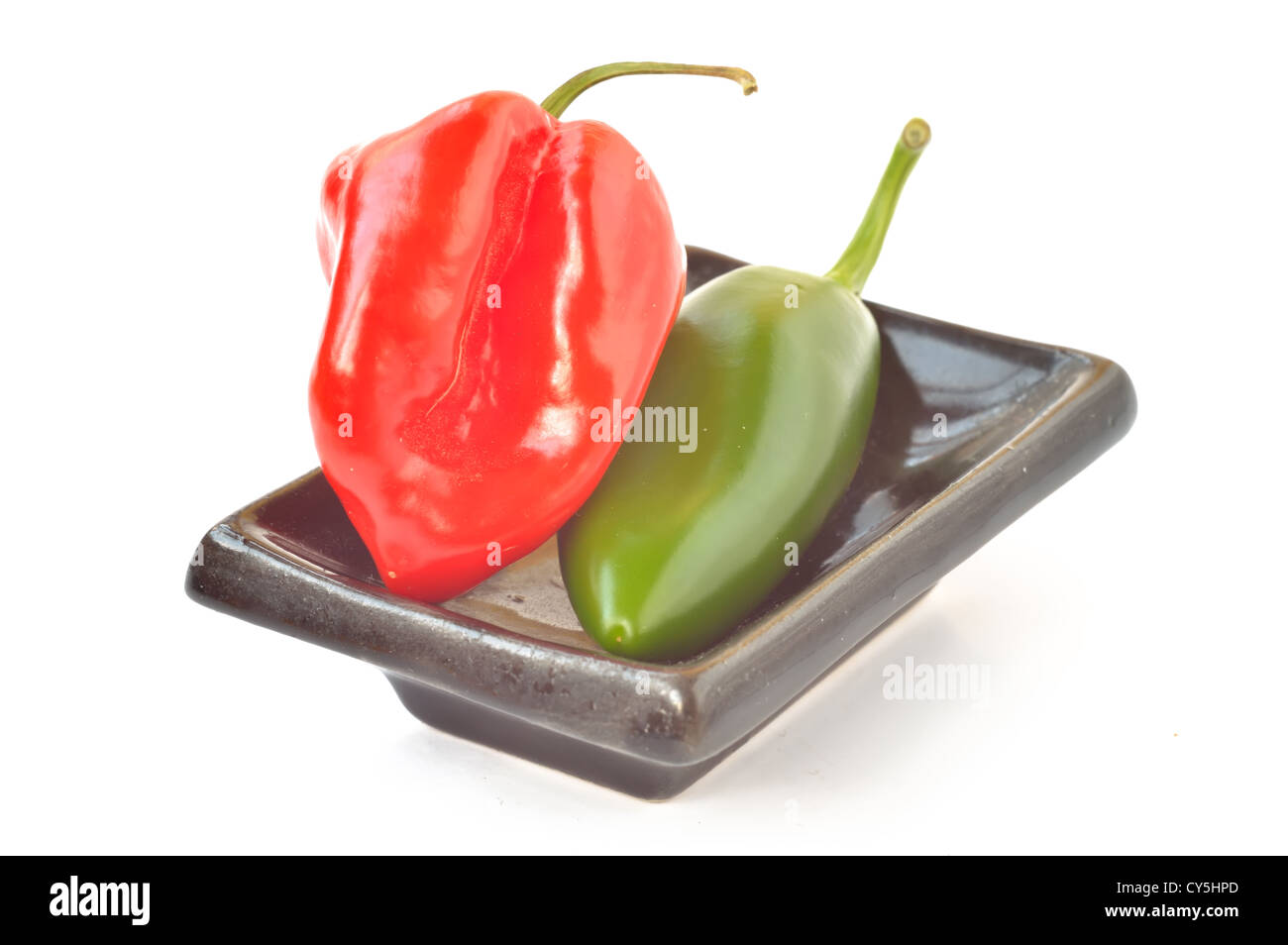 Multi-colored peppers on a white background, close-up Stock Photo - Alamy