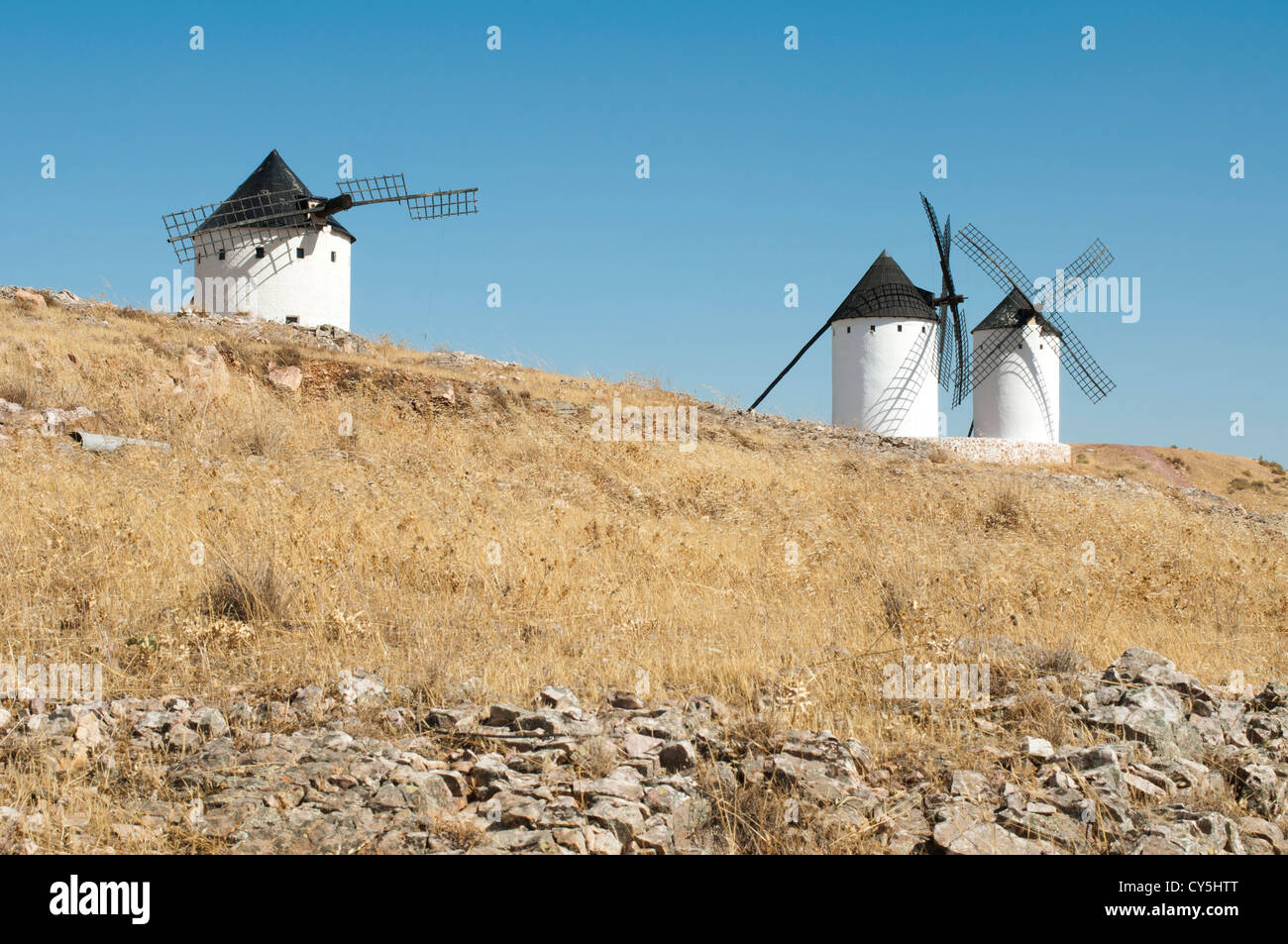 White ancient windmills. Blue sky background Stock Photo - Alamy