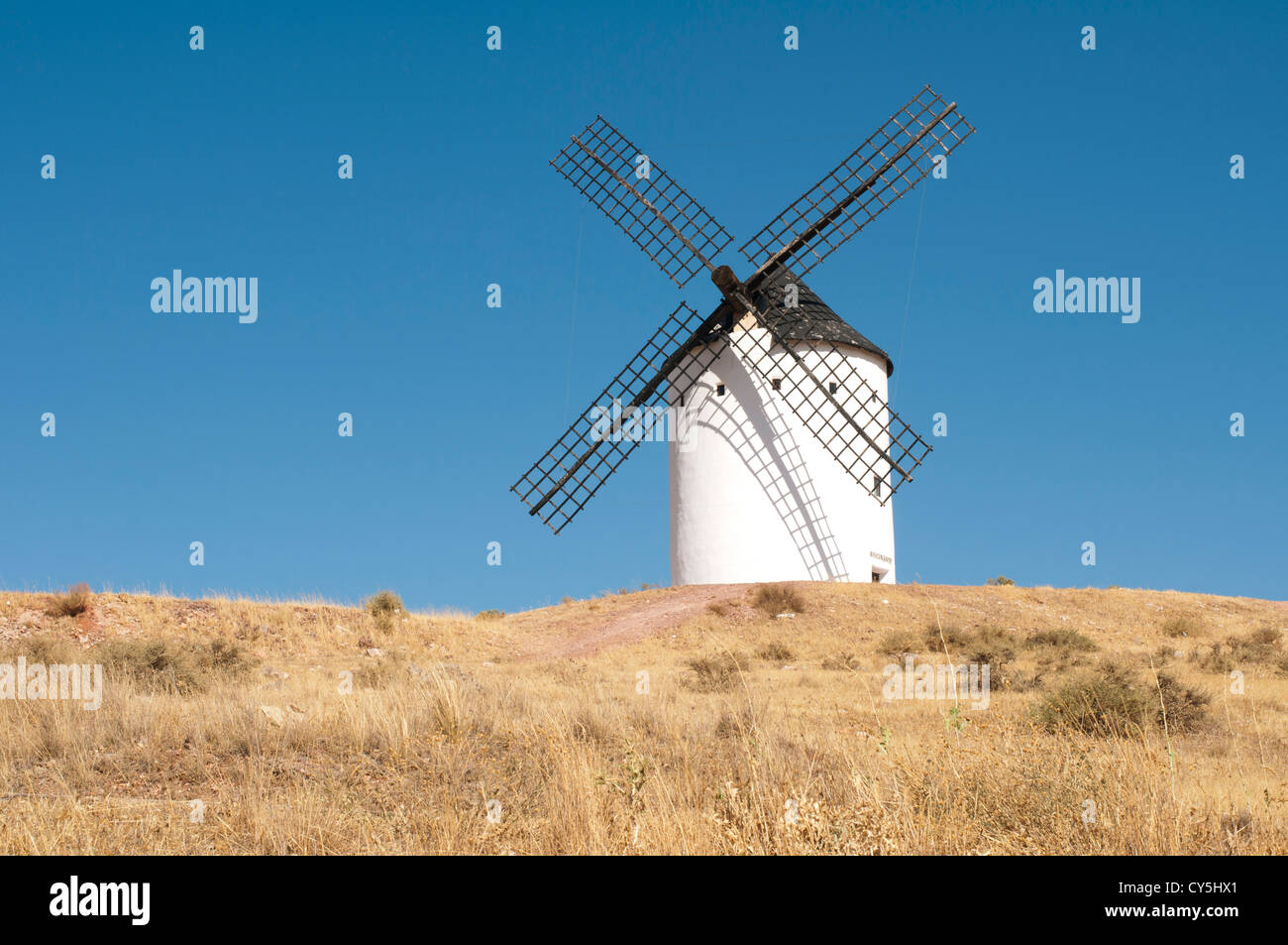 White ancient windmill. Blue sky background Stock Photo - Alamy