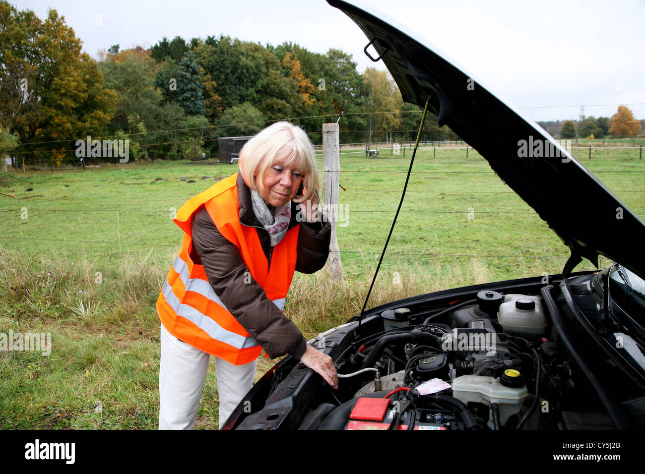 Senior woman has car breakdown Stock Photo - Alamy