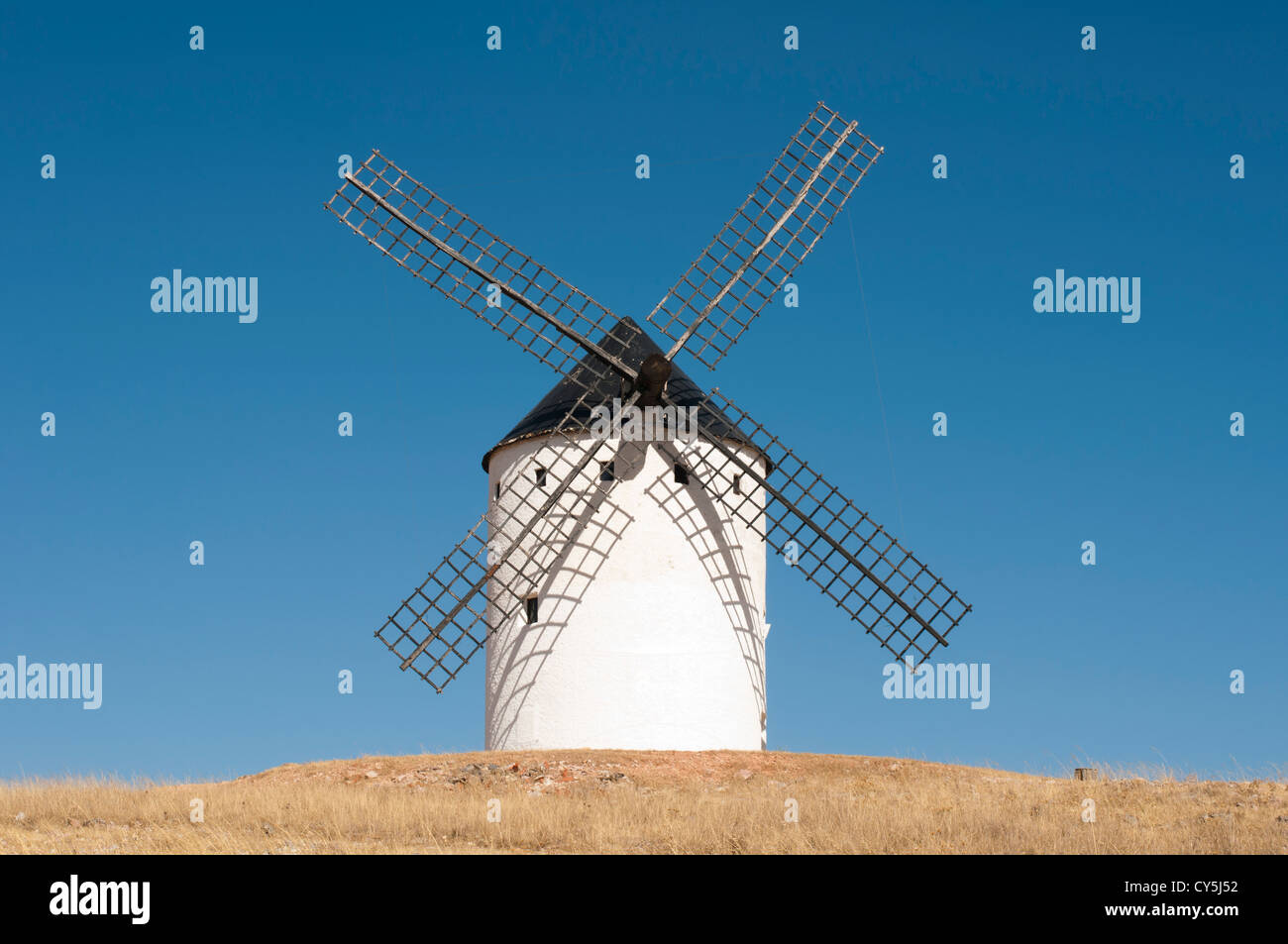 White ancient windmill. Blue sky background Stock Photo - Alamy