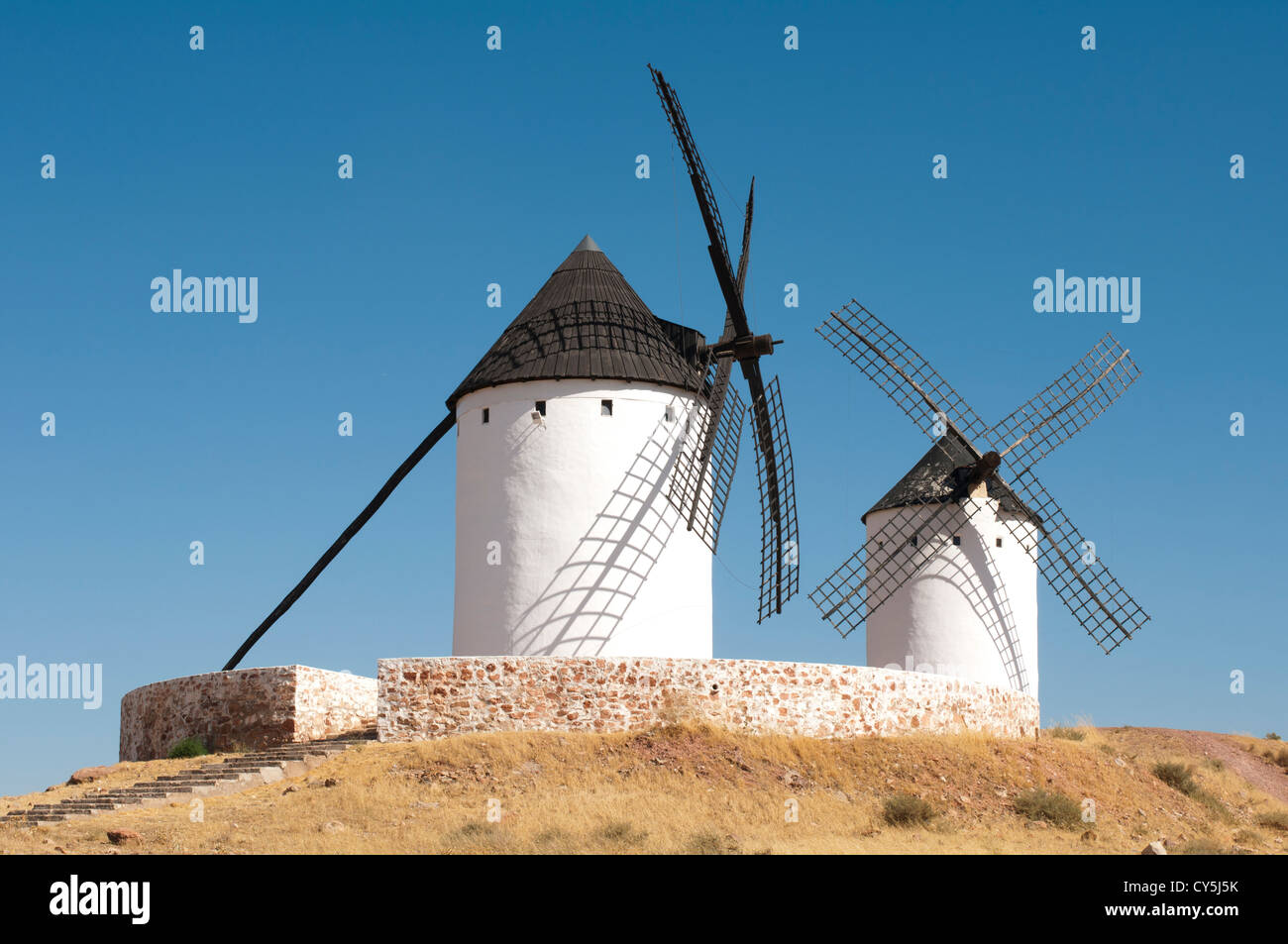 White ancient windmills. Blue sky background Stock Photo - Alamy