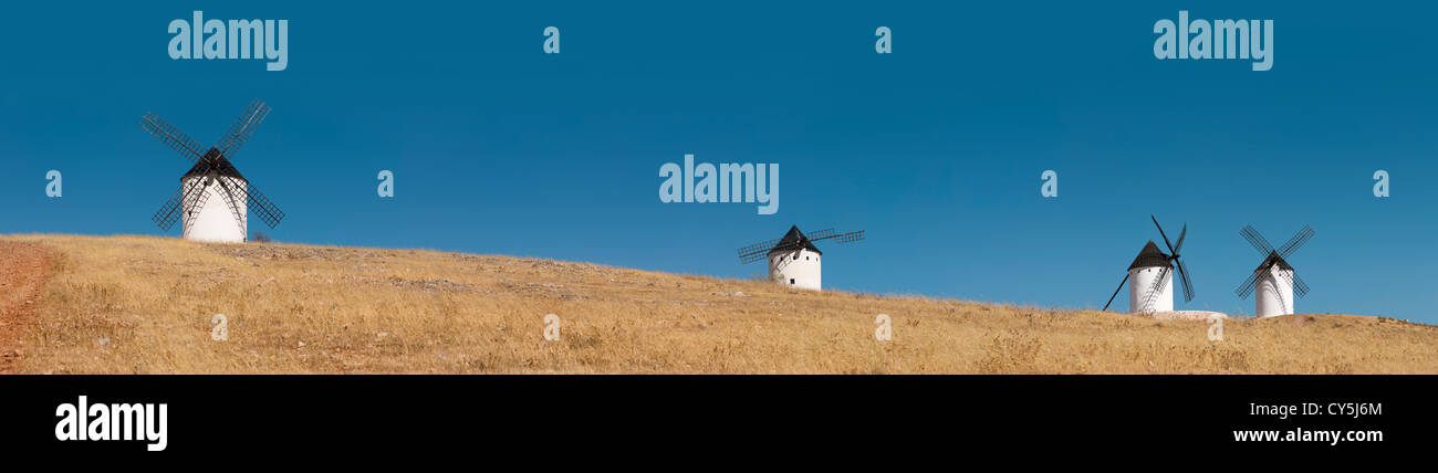 White ancient windmills. Blue sky background Stock Photo - Alamy