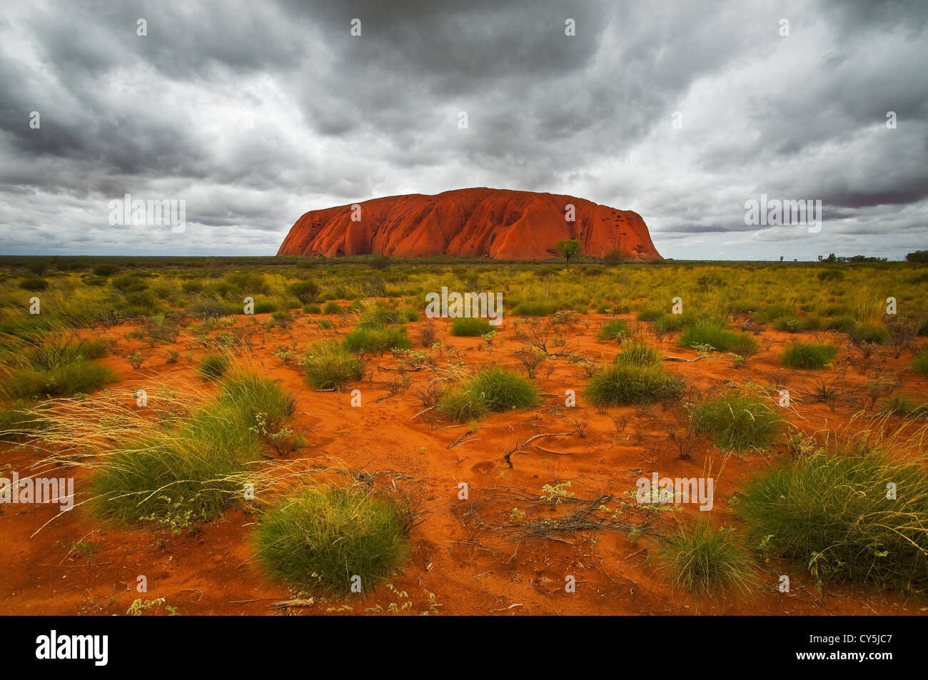 Majestic Uluru under dark clouds Stock Photo - Alamy
