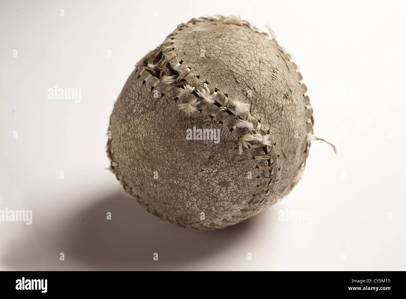 An old battered baseball sits on a white background Stock Photo - Alamy