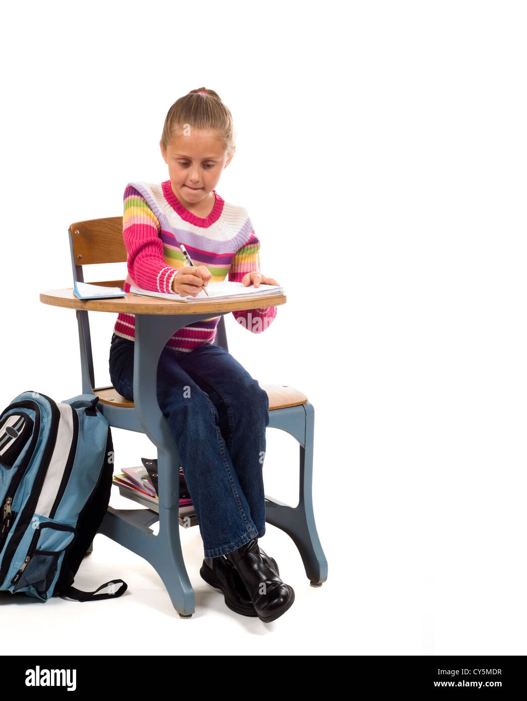 young girl concentrating on work at school desk Stock Photo - Alamy