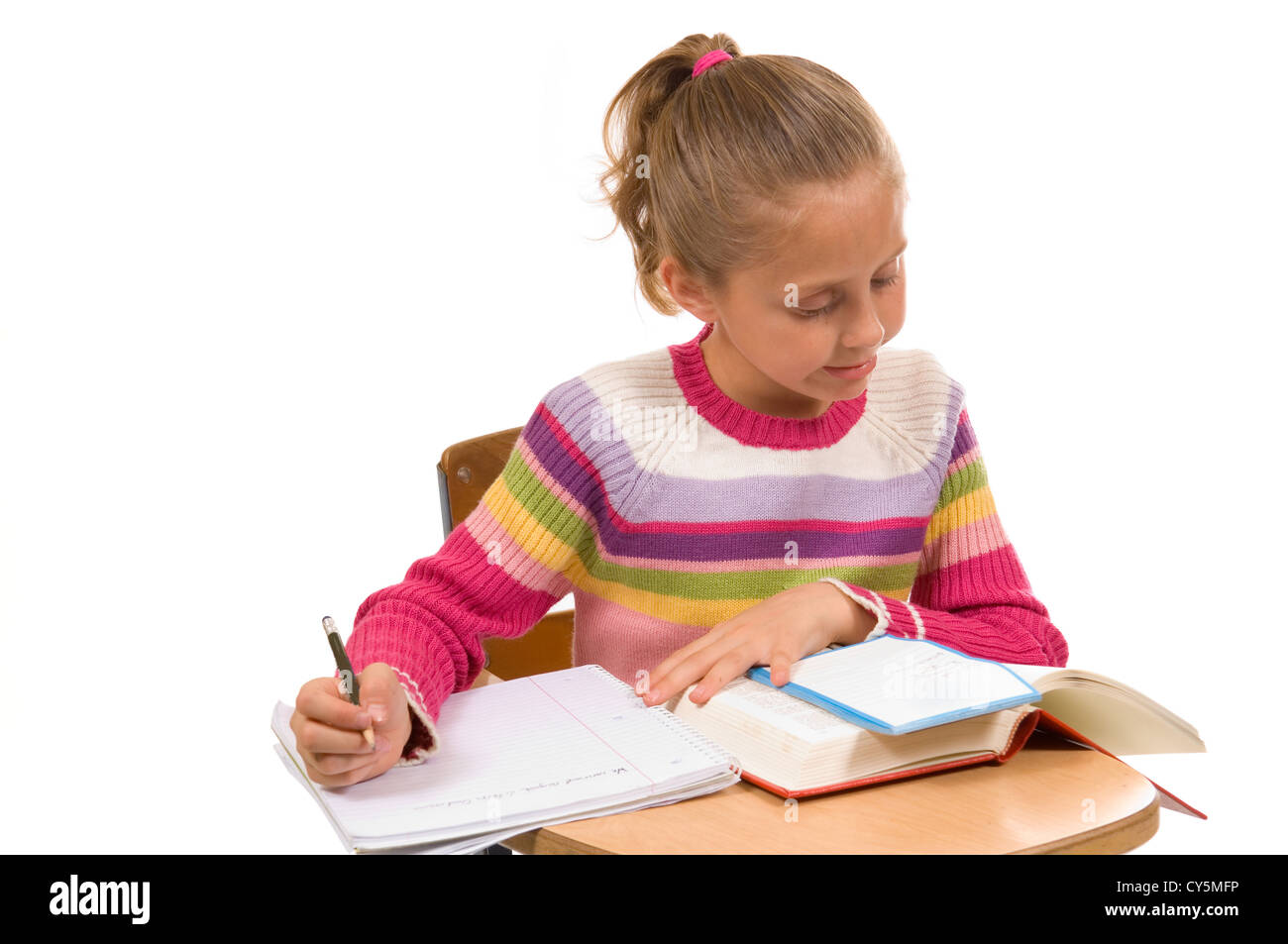 young girl concentrating on work at school desk Stock Photo - Alamy