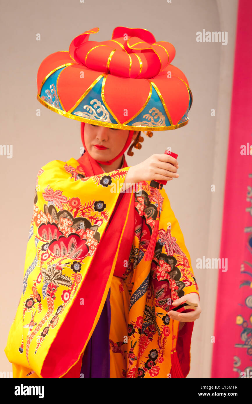 A woman dancer in traditional Okinawan (Ryukyu) kimono performs on ...
