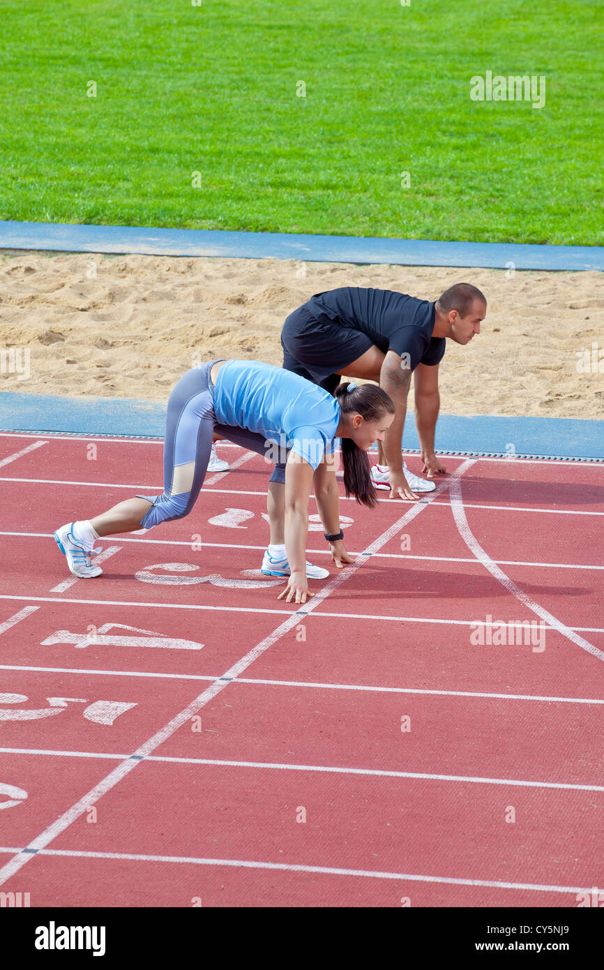 Man and woman on the starting line at the stadium on a sunny day Stock ...