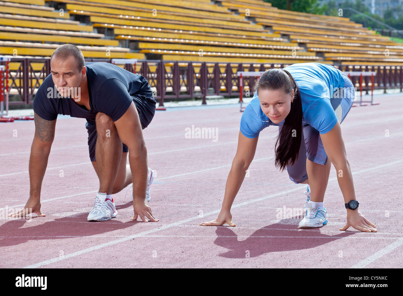Two athletes on the starting line at the stadium Stock Photo - Alamy