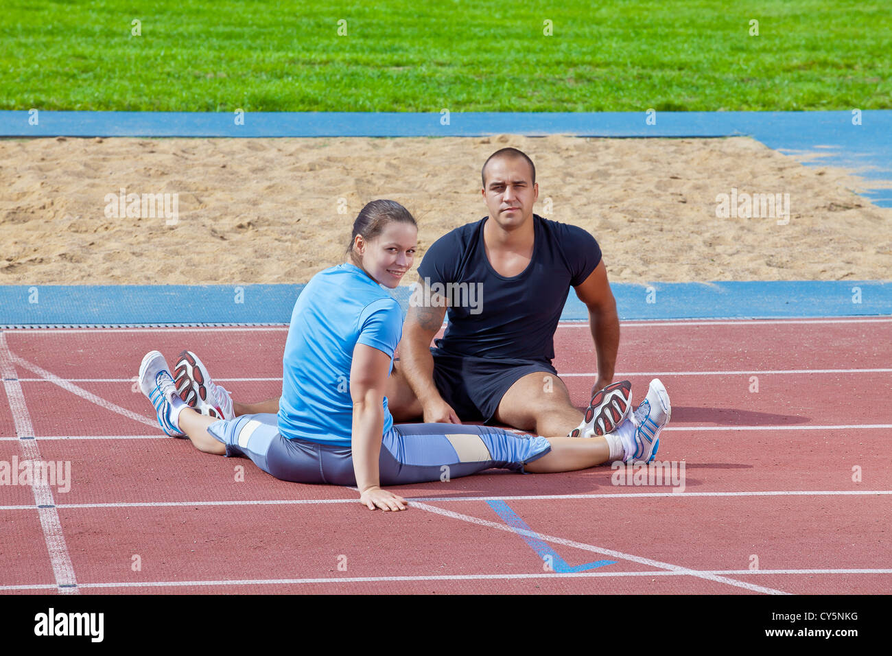 Two athletes resting at the stadium on a sunny day Stock Photo - Alamy