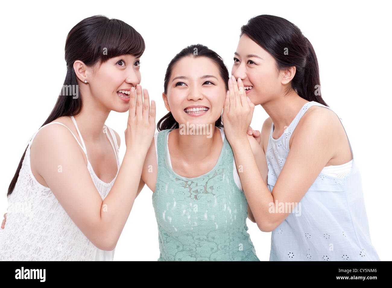 Best female friends whispering together Stock Photo - Alamy