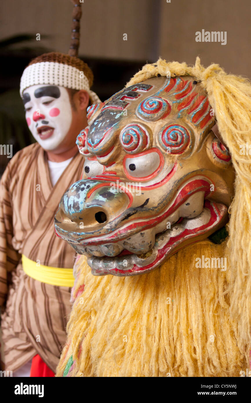 A lion god - Shiisa performs for visitors to Ryukyu Mura - a theme park ...