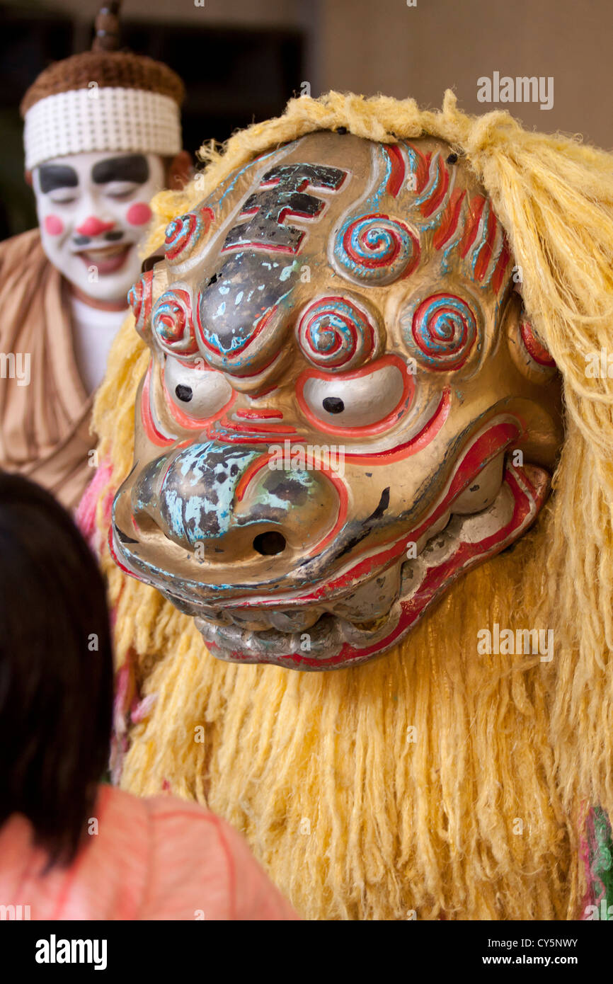 A lion god - Shiisa performs for visitors to Ryukyu Mura - a theme park ...