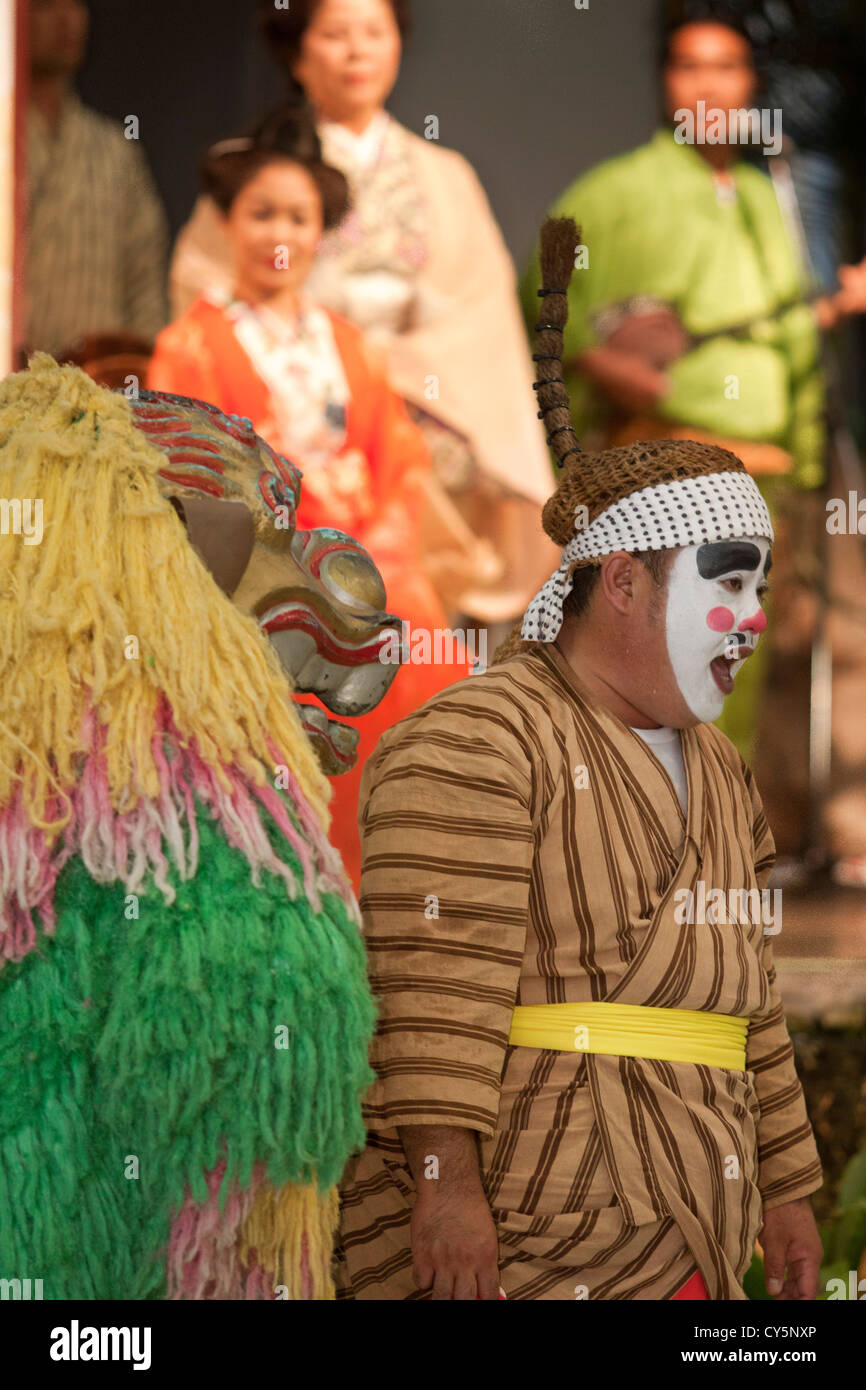 A lion god - Shiisa performs for visitors to Ryukyu Mura - a theme park ...