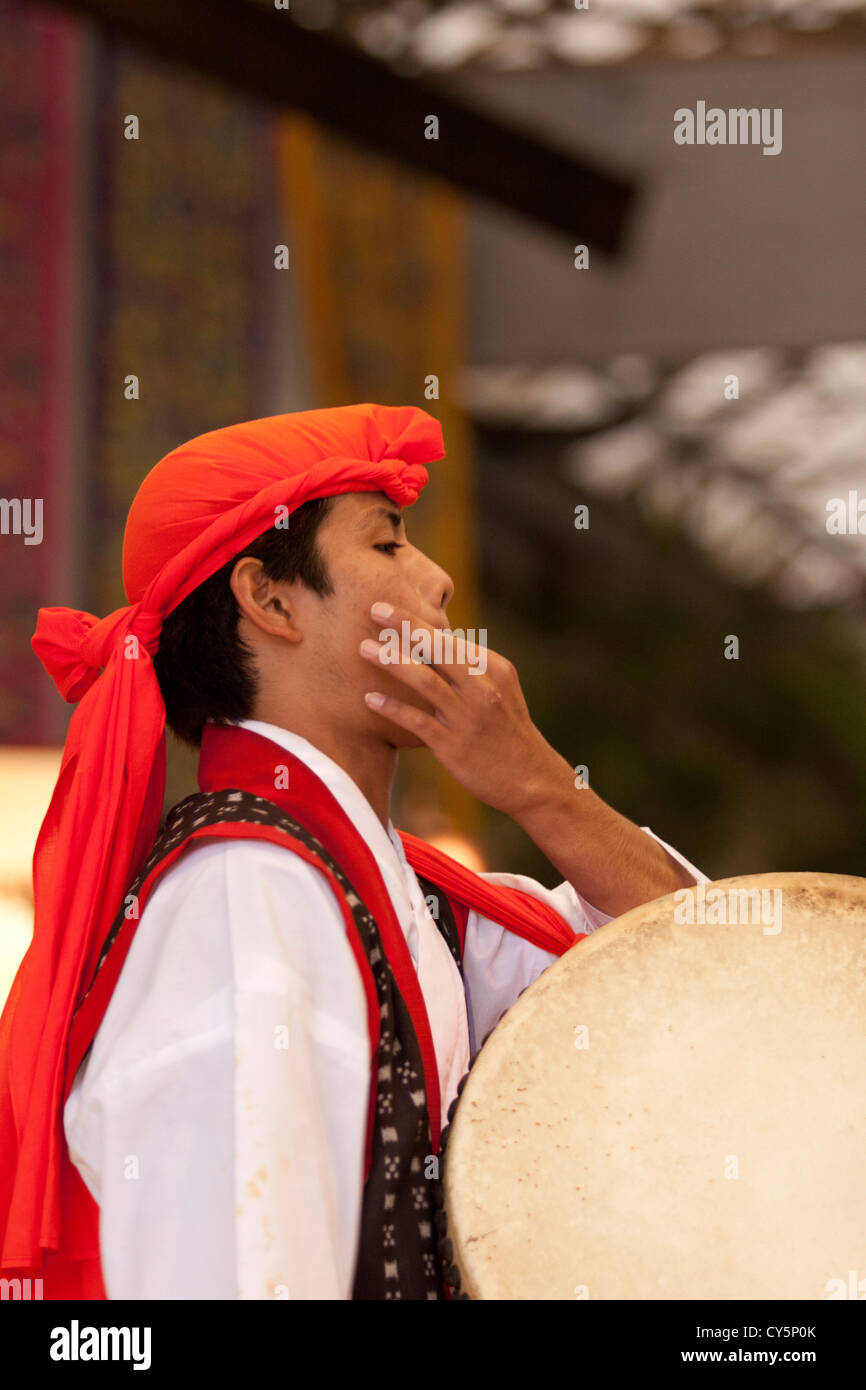 A male dancer performs a traditional Okinawan dance at Ryukyu Village ...