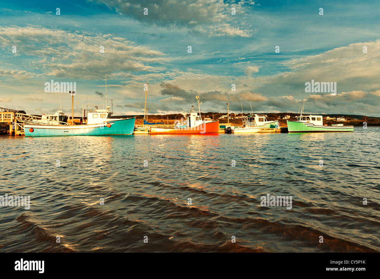 Fishing boat during sunset in the harbour with dramatic sky Stock Photo ...