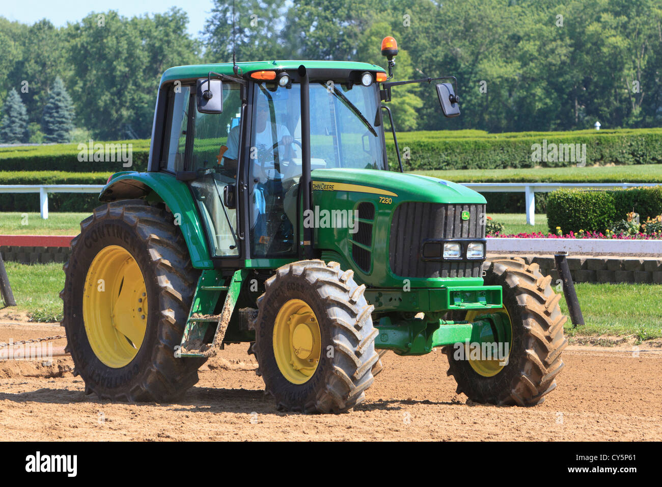Tractor on horse racetrack grooming the surface for a race Stock Photo ...