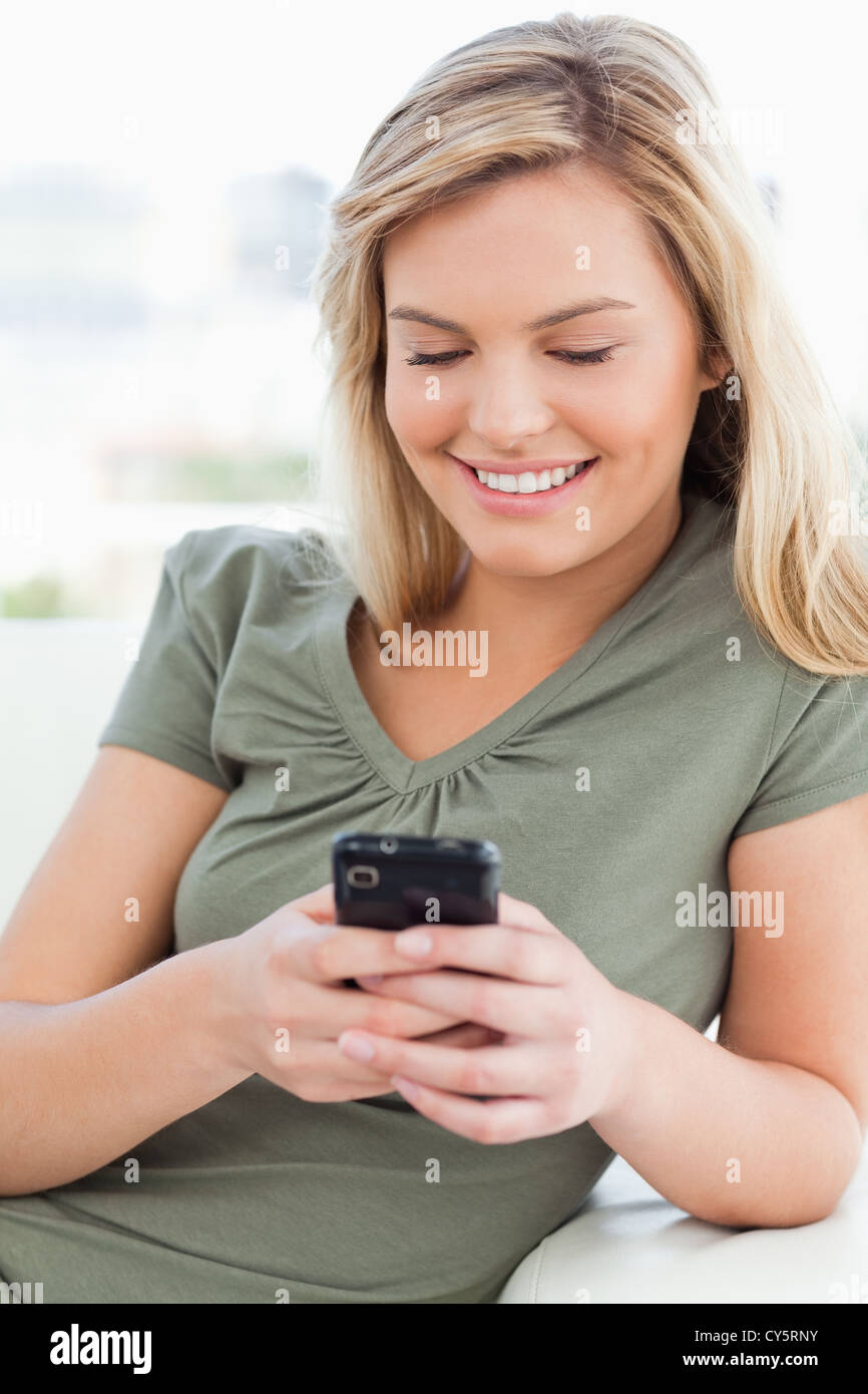 Close up, woman smiling and using her phone Stock Photo - Alamy