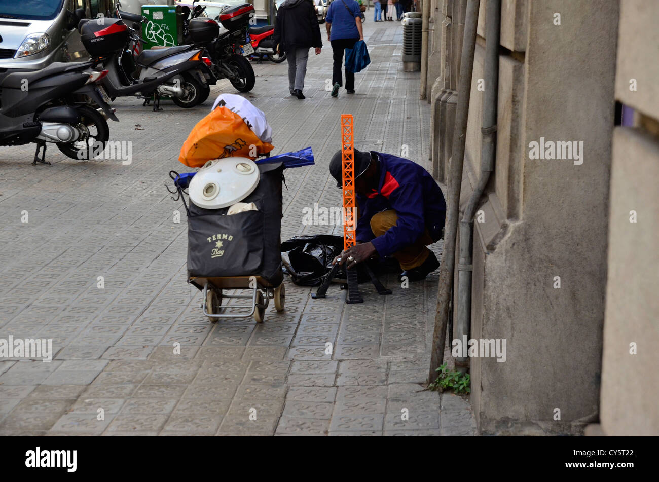Black person collecting junk in the streets of Barcelona Stock Photo ...