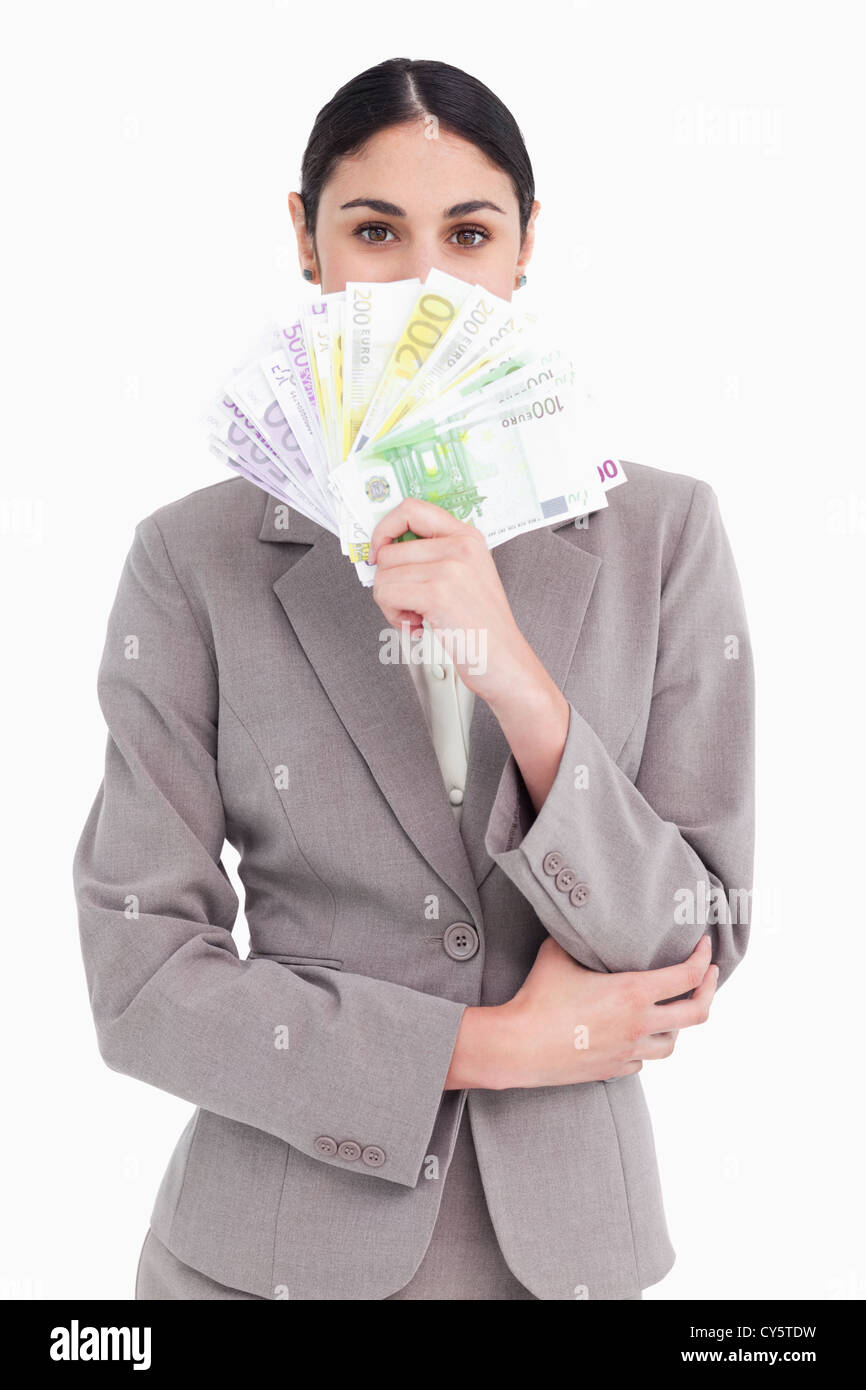 Young businesswoman hiding her face behind bank notes Stock Photo - Alamy