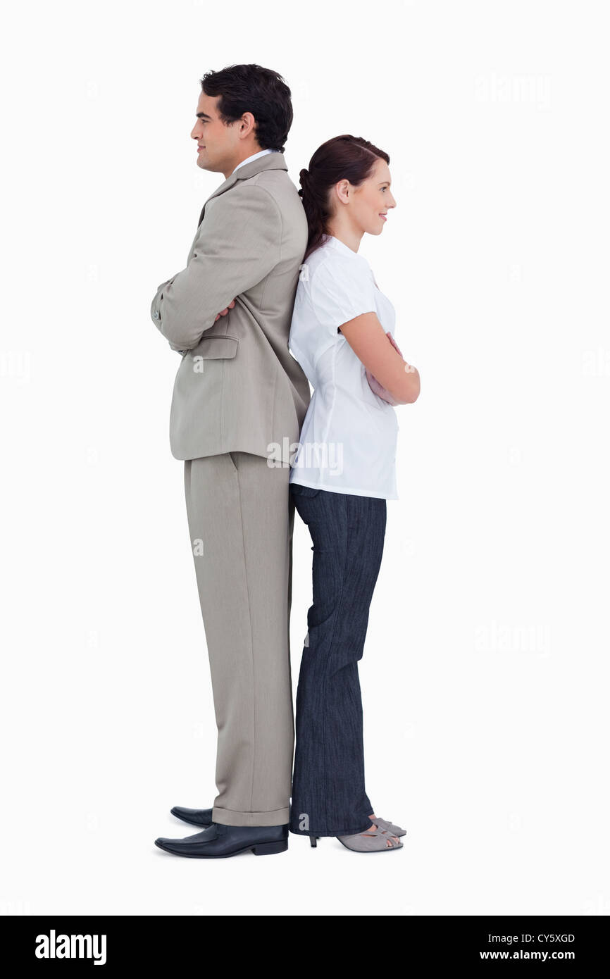 Salesteam standing back to back Stock Photo - Alamy