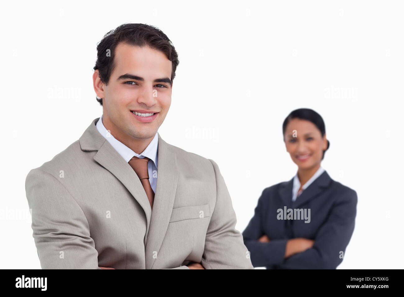 Smiling salesman with co-worker behind him Stock Photo - Alamy