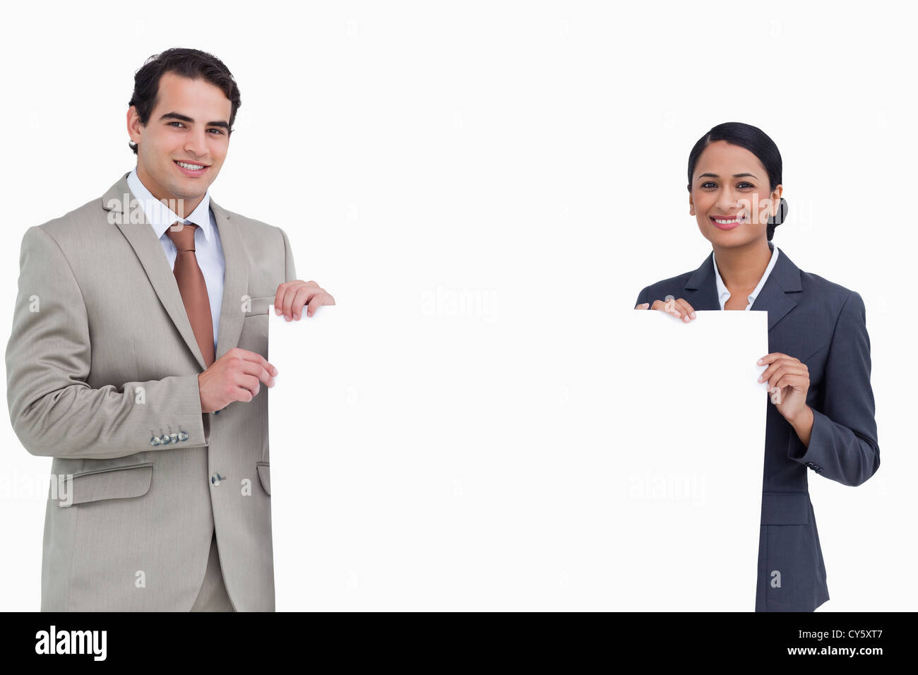 Smiling salesteam holding blank sign Stock Photo - Alamy