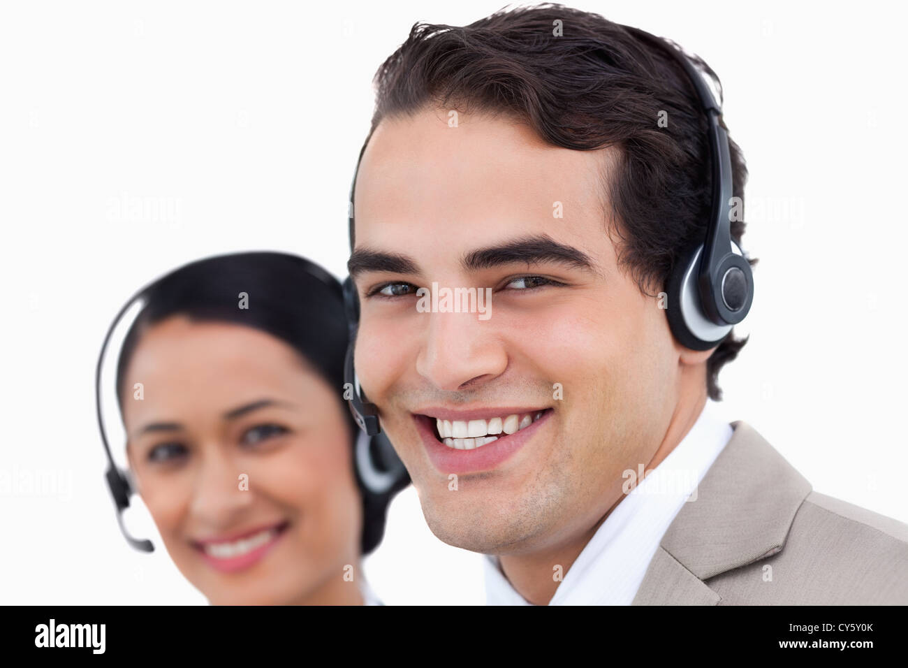 Close up side view of smiling call center agents at work Stock Photo ...