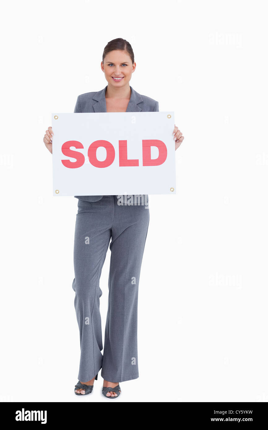 Happy real estate agent holding sold sign Stock Photo - Alamy