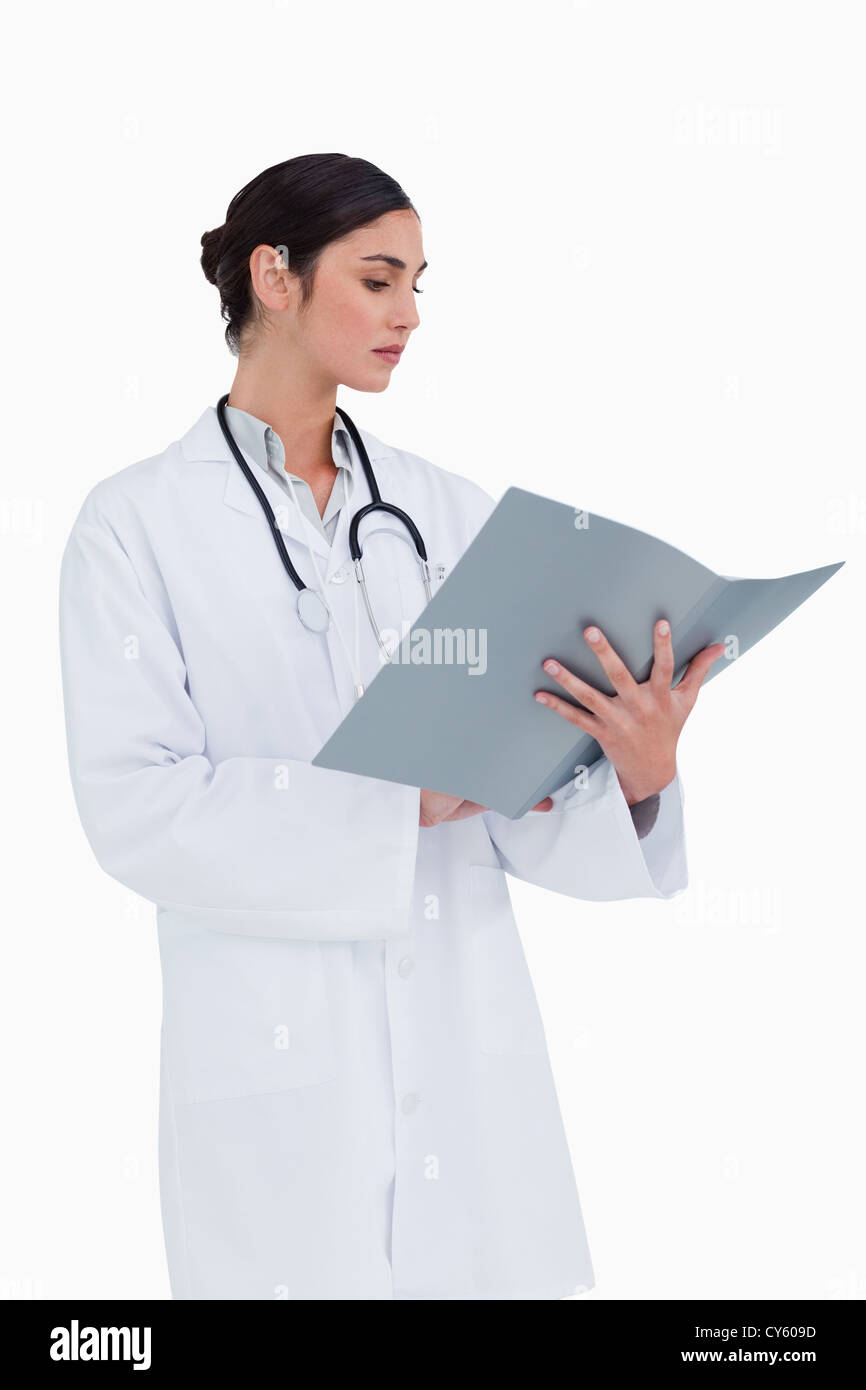 Side view of female doctor reading patients record Stock Photo - Alamy