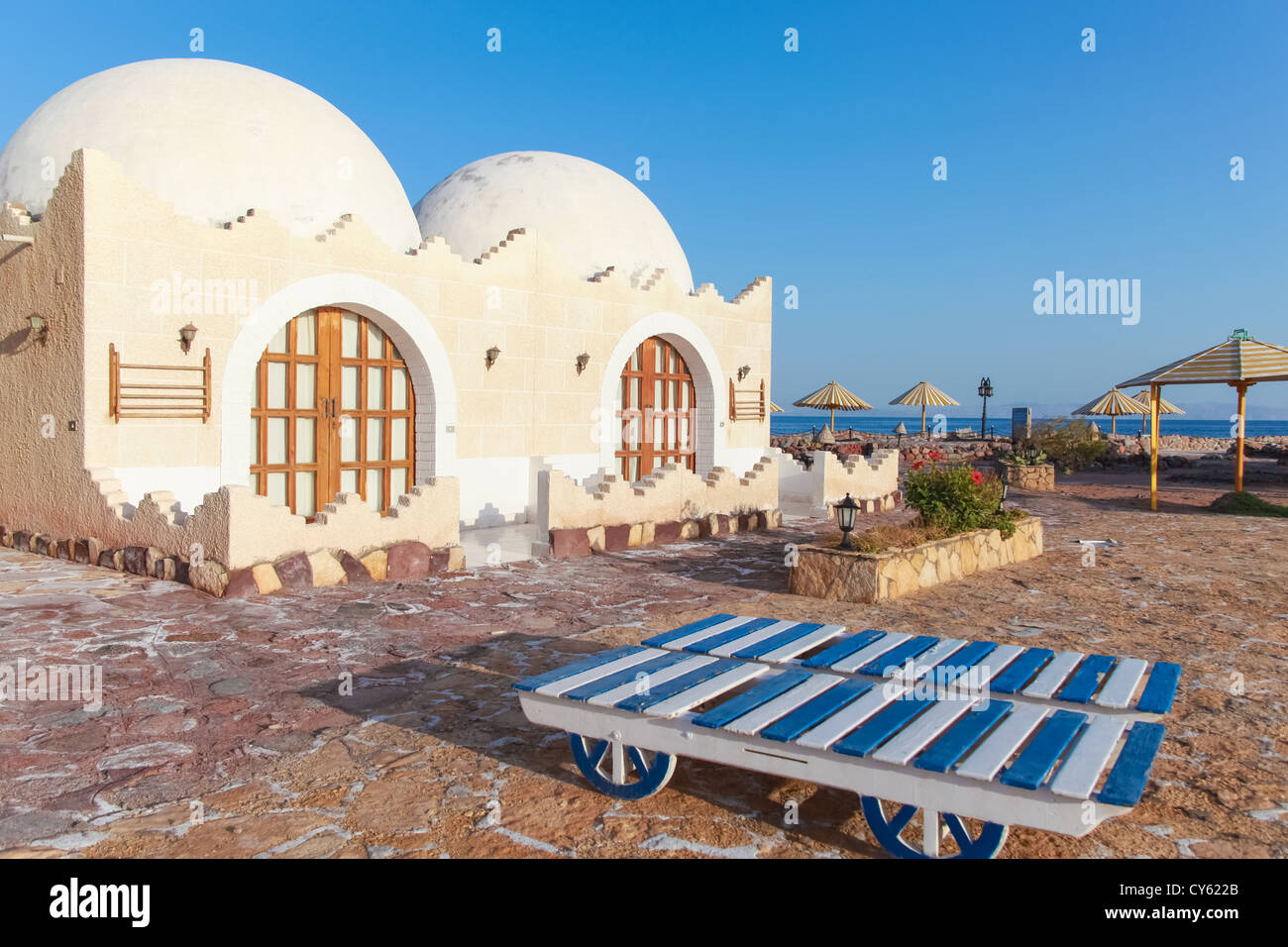 Deck chairs in front of the bungalows in the resort in Dahab, Egypt ...