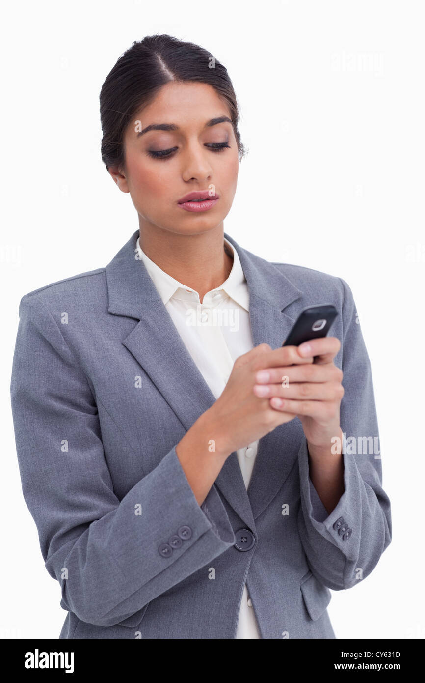 Female entrepreneur writing text message on her cellphone Stock Photo ...