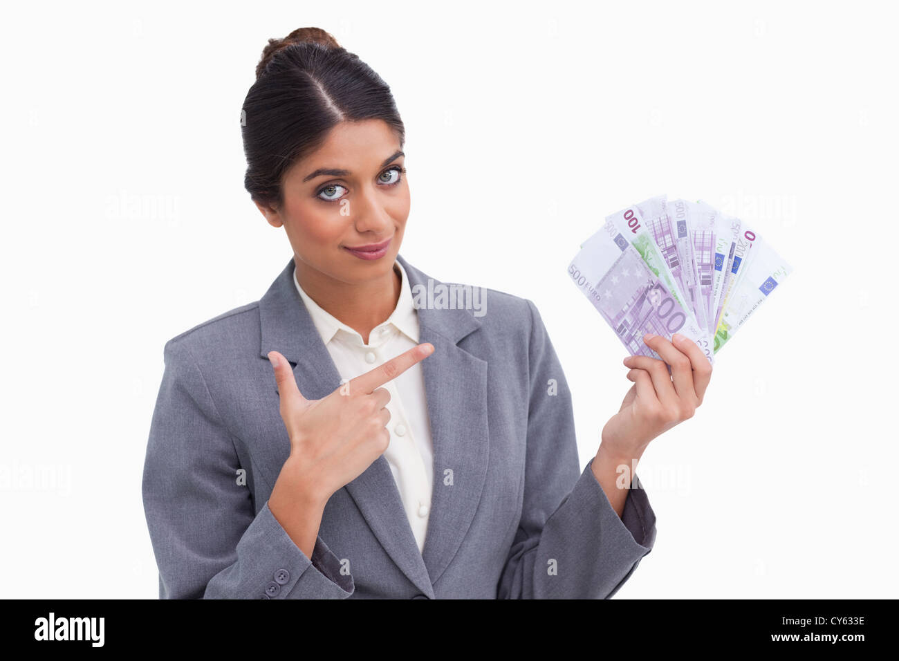 Female entrepreneur pointing at money in her hand Stock Photo - Alamy