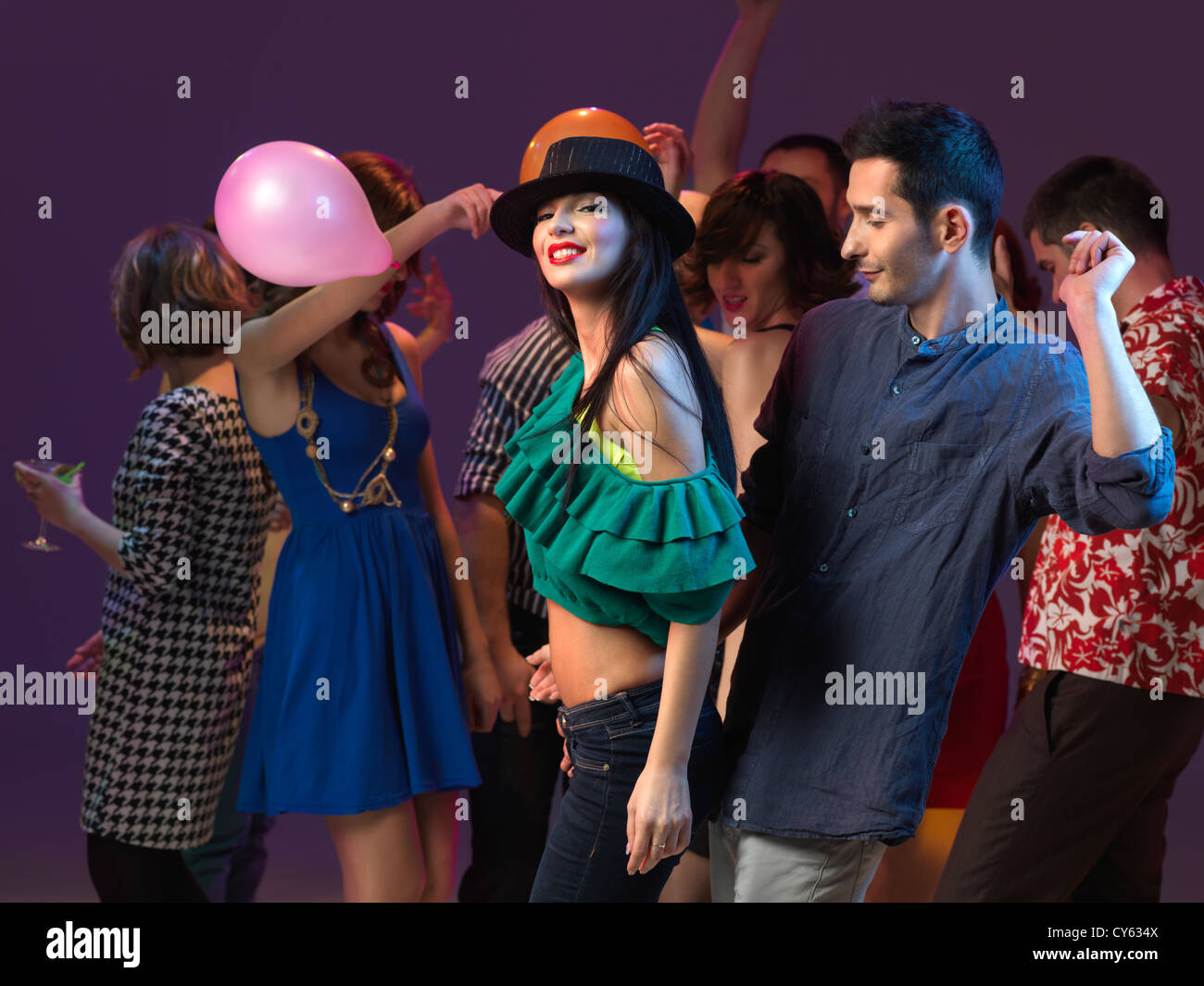 young beuatiful gilr smiling to the camera, dancing with young guy ...