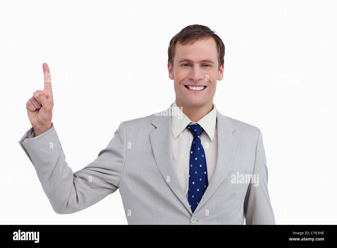 Close up of smiling businessman pointing up Stock Photo - Alamy
