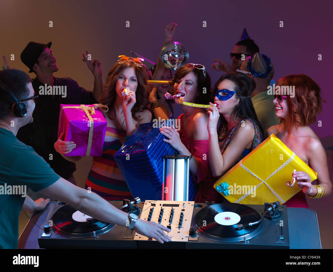 Partial Backview Of A Dj Mixing With Girls Blowing Party Horns And