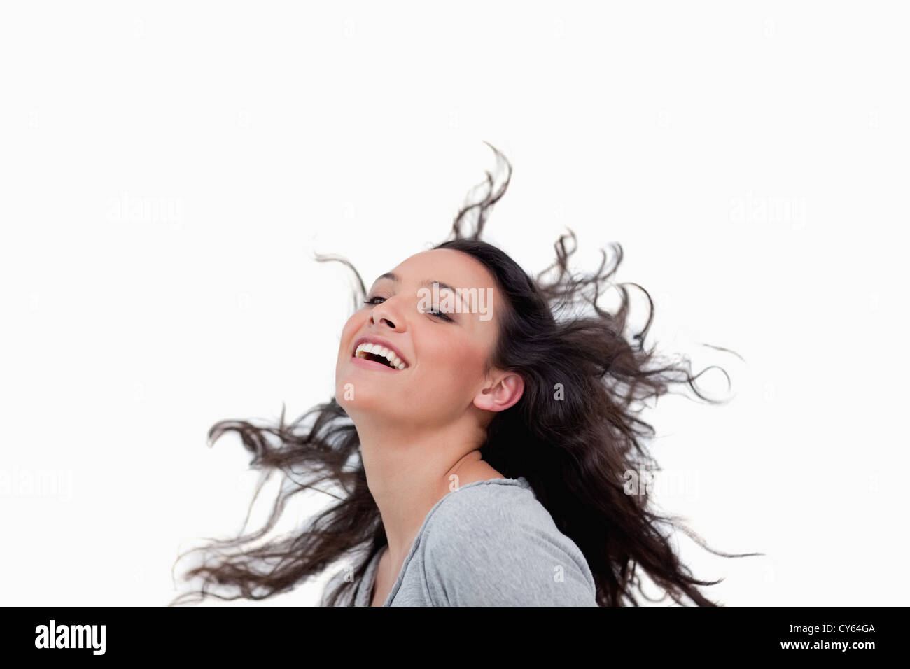 Smiling woman flipping her hair Stock Photo - Alamy