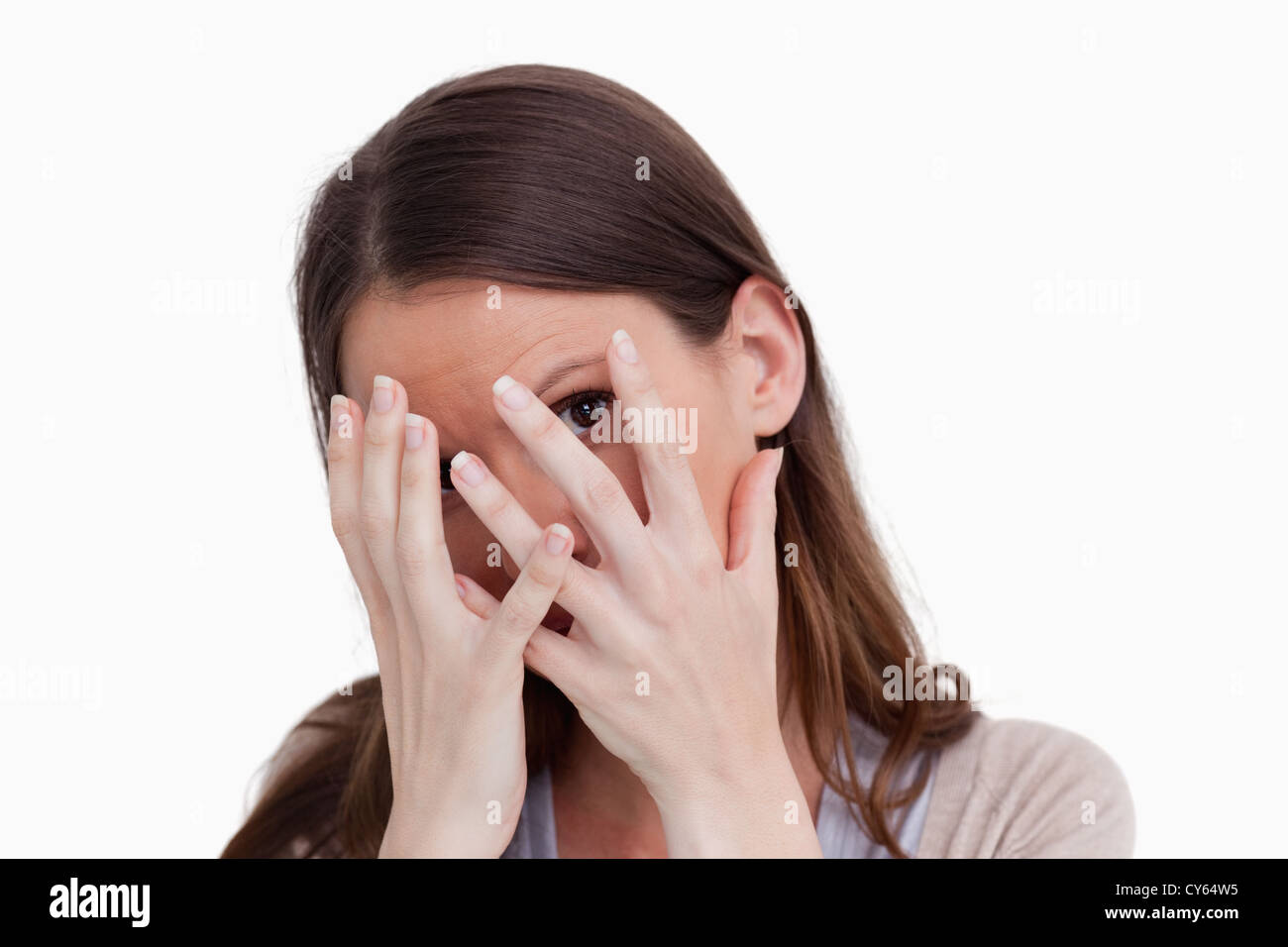 Hiding face behind fingers hi-res stock photography and images - Alamy