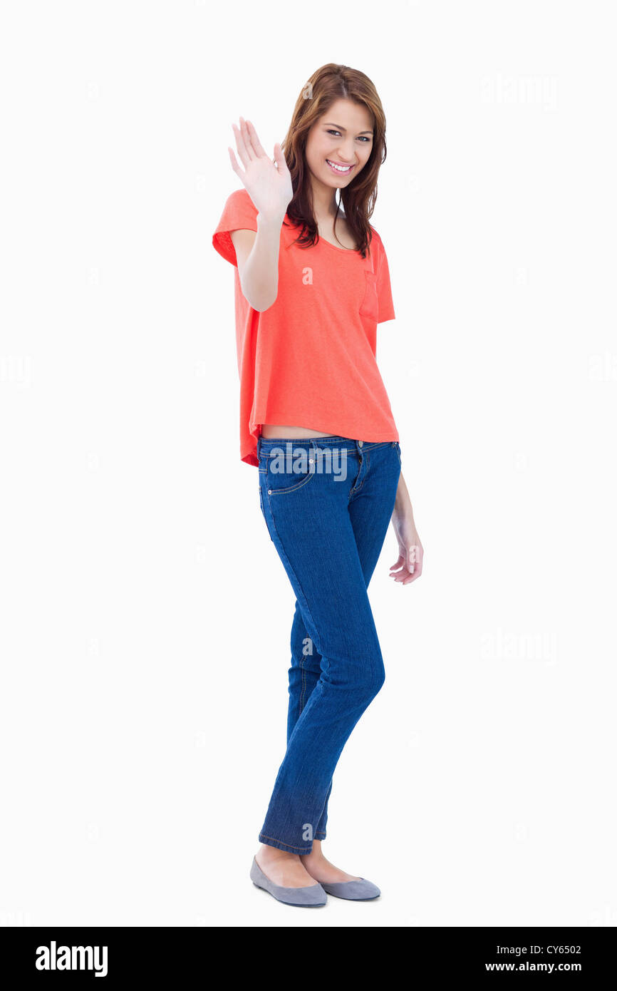 Young woman raising her hand as a greeting Stock Photo - Alamy