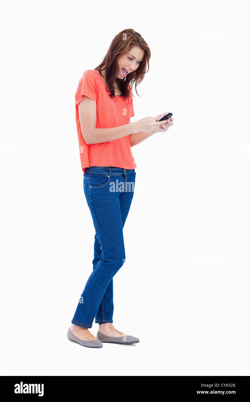 Surprised teenager after receiving a text Stock Photo - Alamy