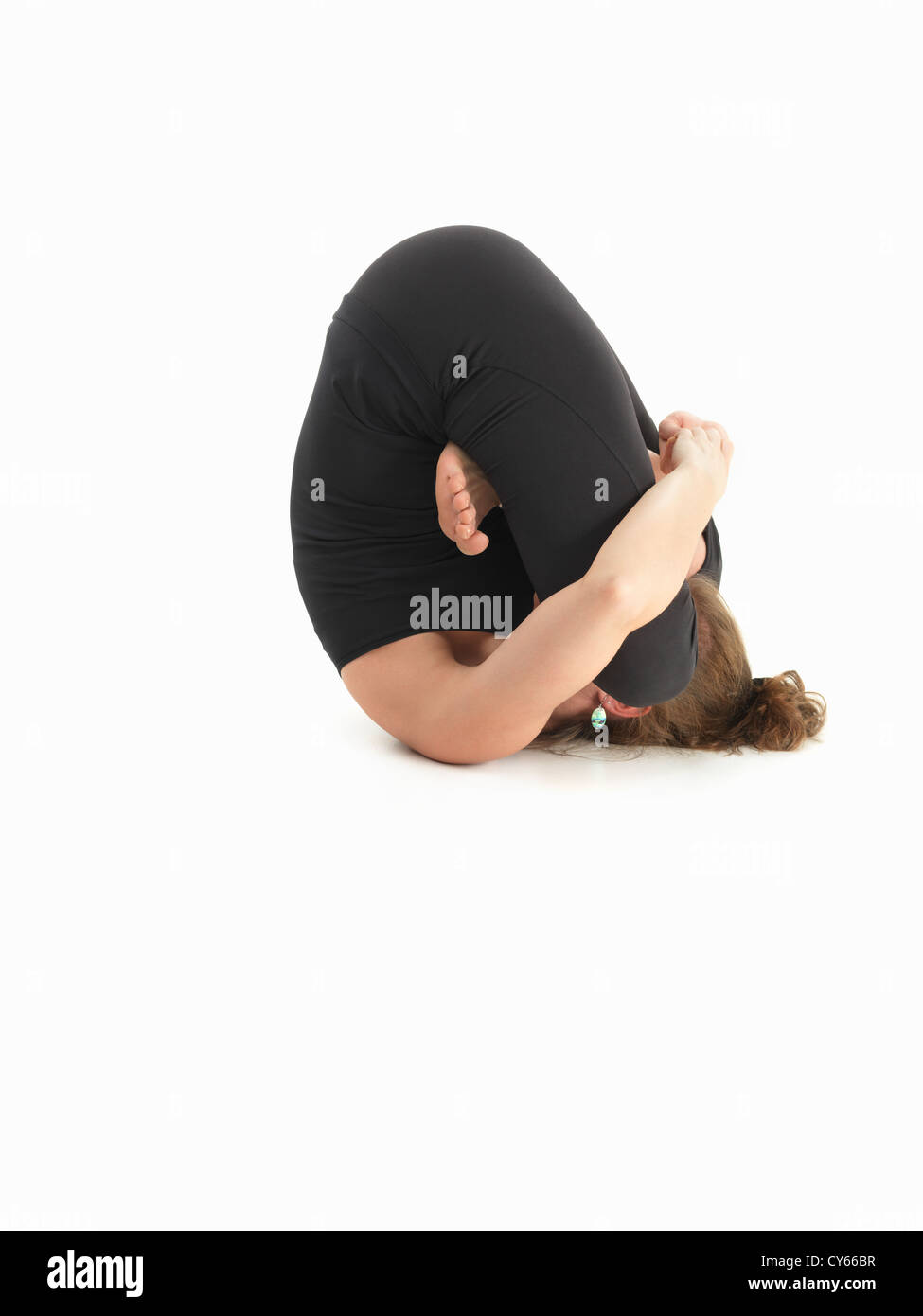 young woman in yoga pose, face invisible, body side view, dressed in ...