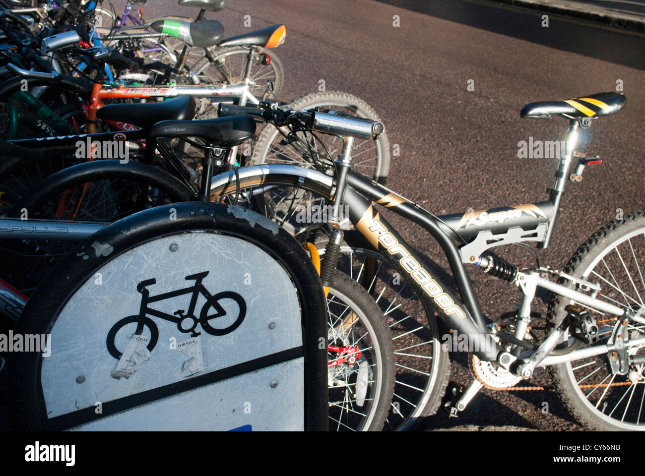 Large row of cycles parked in Cambridge with cycle parking sign Stock ...