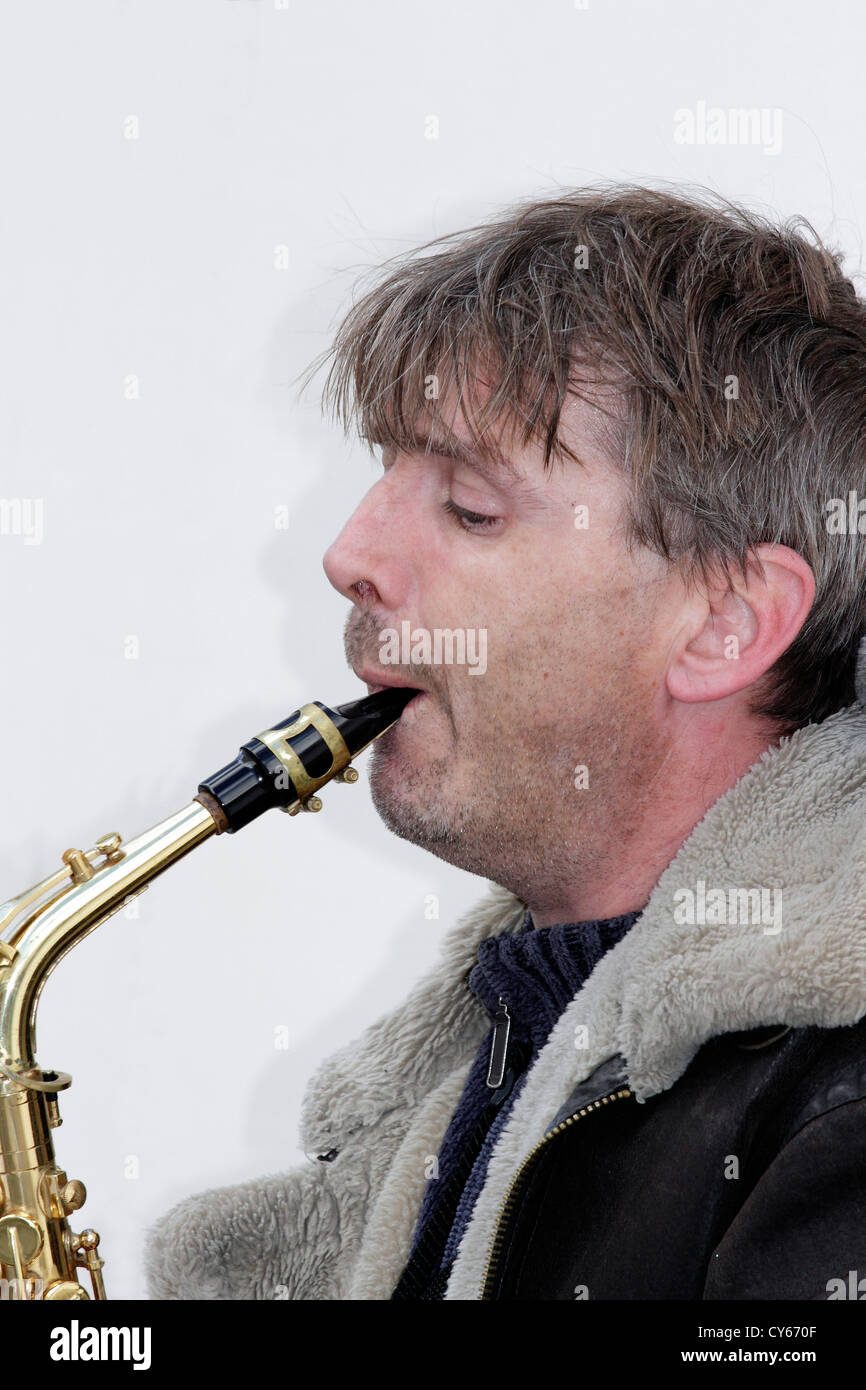 Male busker playing saxophone hi-res stock photography and images - Alamy