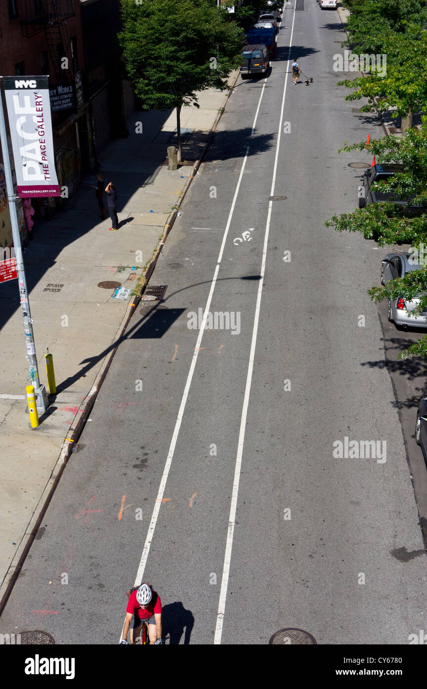 An aerial view of a long cycle lane with a cyclist exiting the frame ...