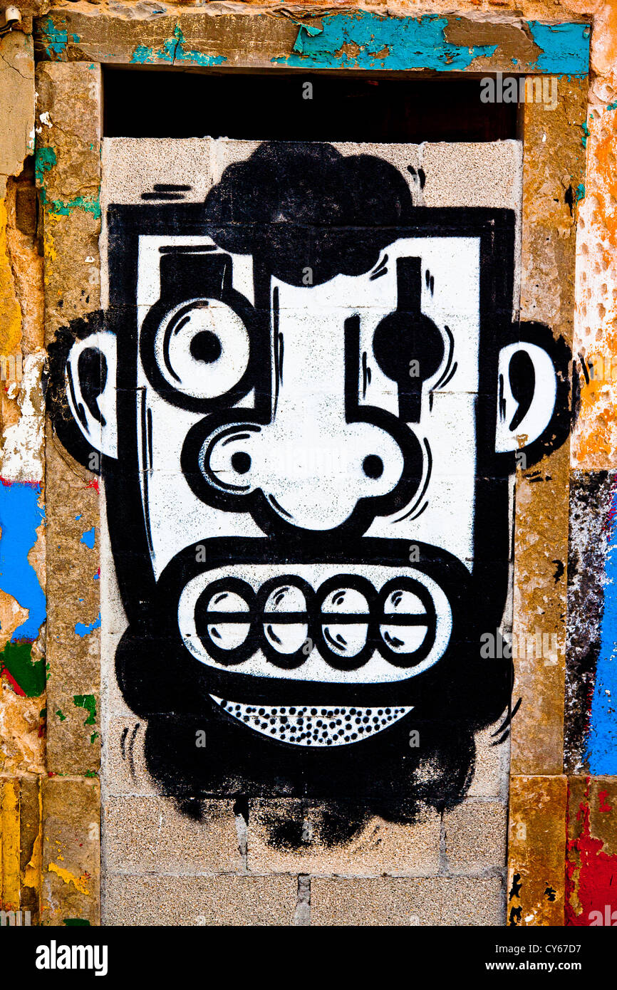 Graffiti of a face in Faro back streets Stock Photo - Alamy