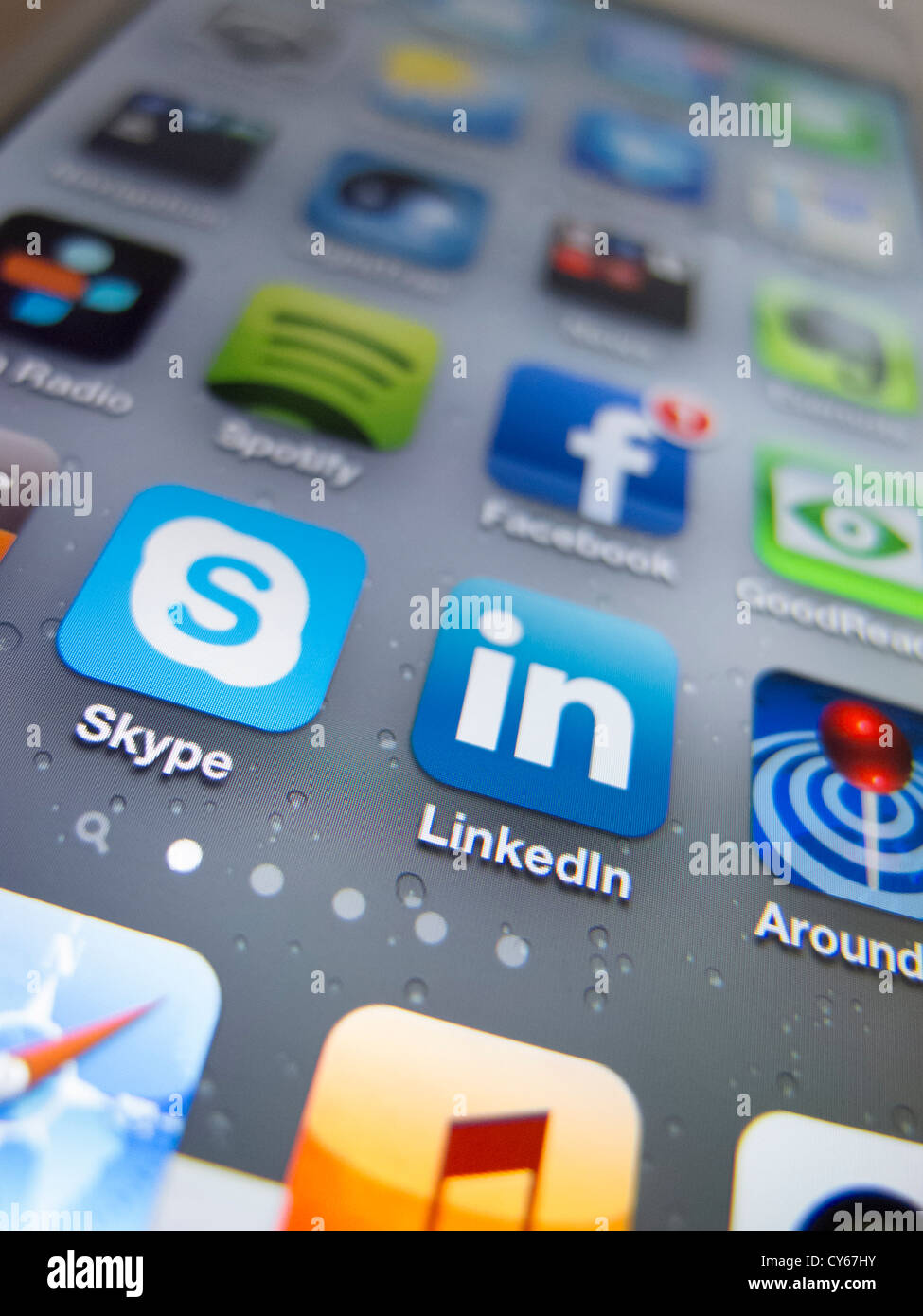 Close-up of new iPhone 5 smart phone showing screen with many apps ...