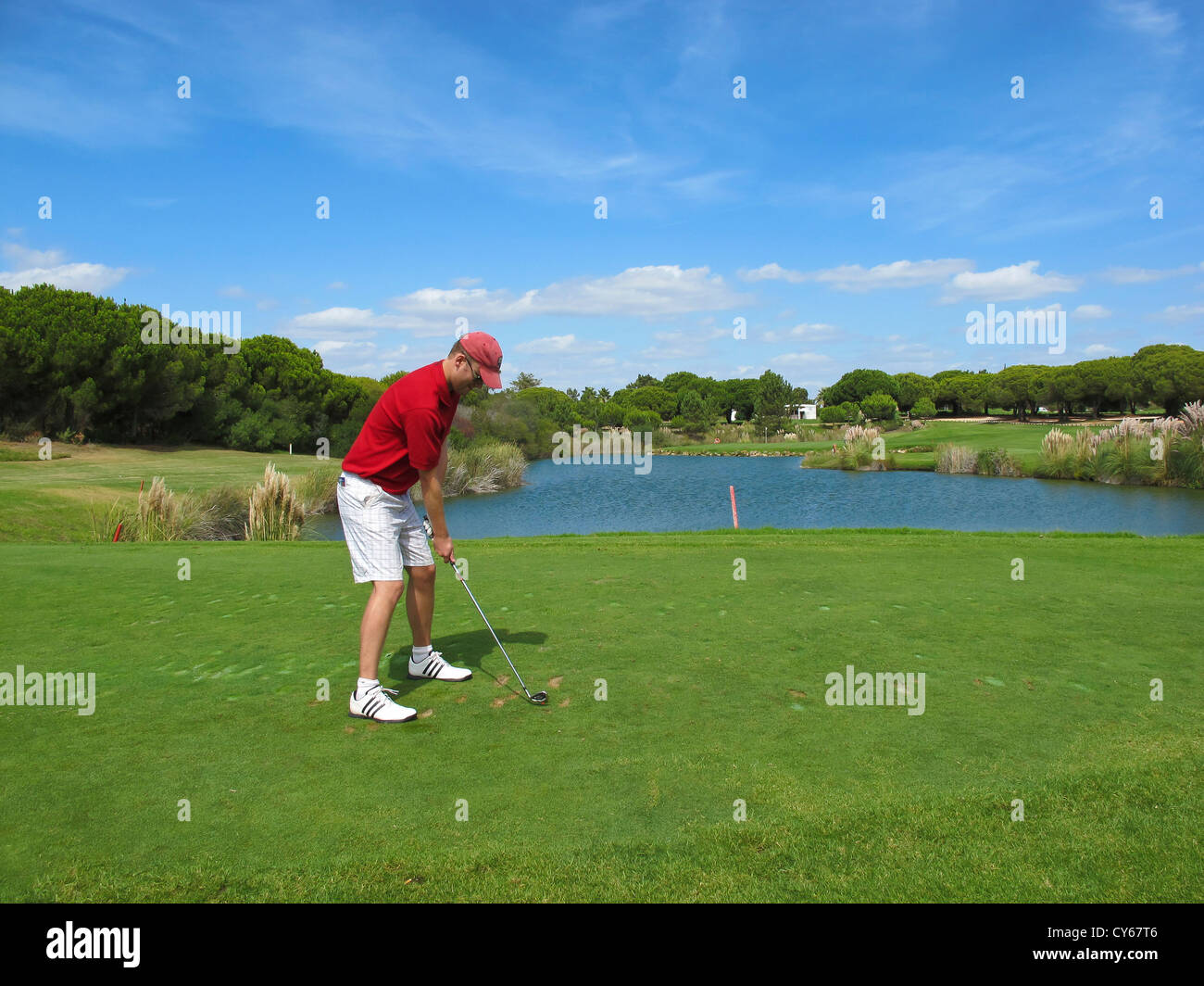 Golfer hitting shot over water hi-res stock photography and images - Alamy