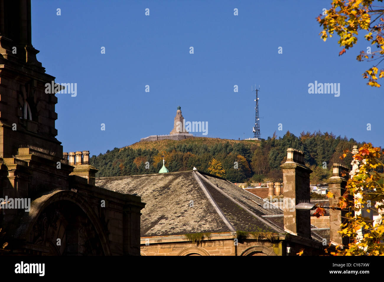 Landscape view of the Law Hill monument between rooftops and trees in ...